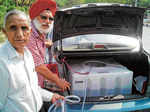Dwarka residents use car; water roadside saplings