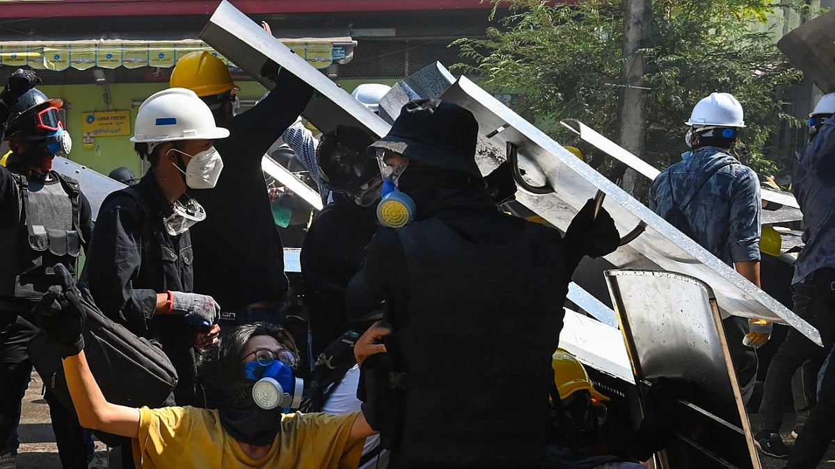 Myanmar protesters defy curfew; media outlets ordered shut