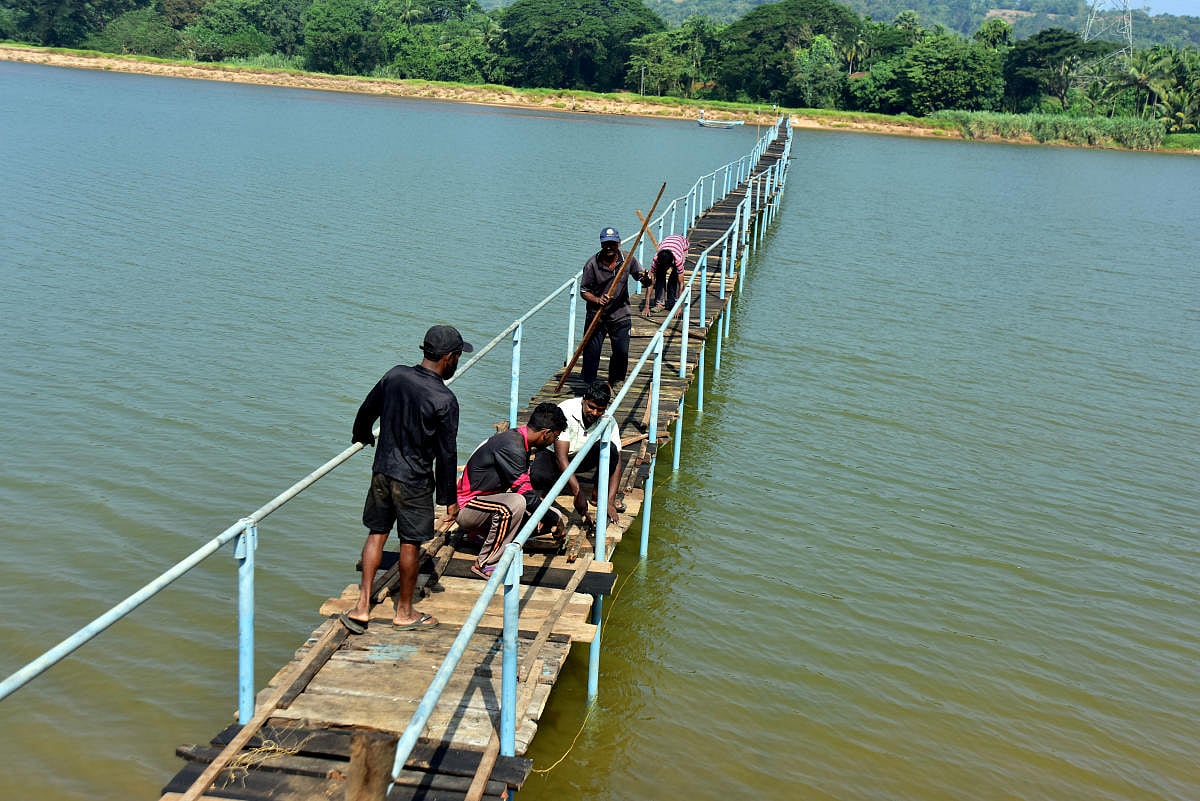 Villagers build makeshift bridge to cross river